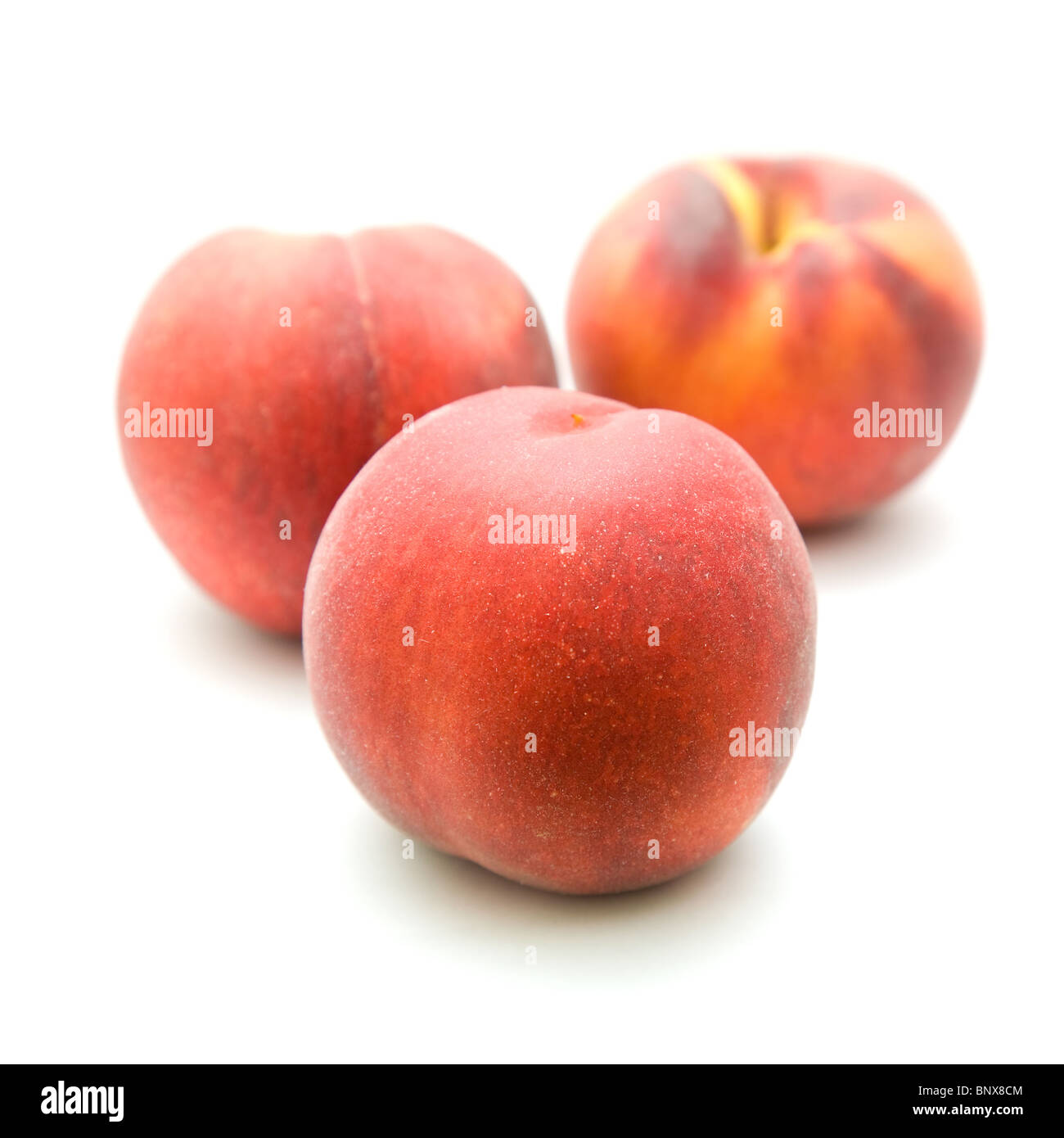three ripe red peaches isolated on white background Stock Photo - Alamy