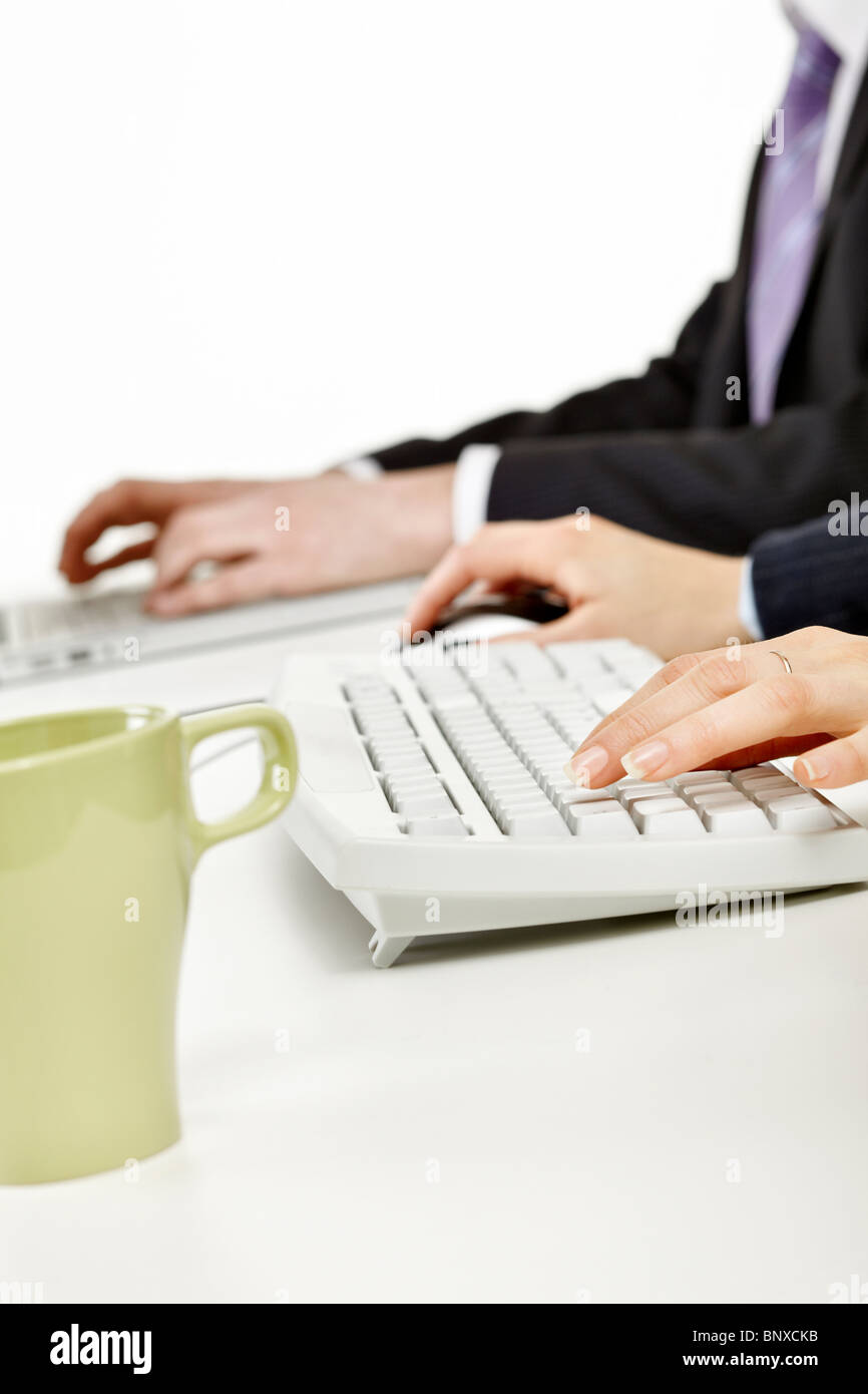 Good looking business people working on computers on white background ...