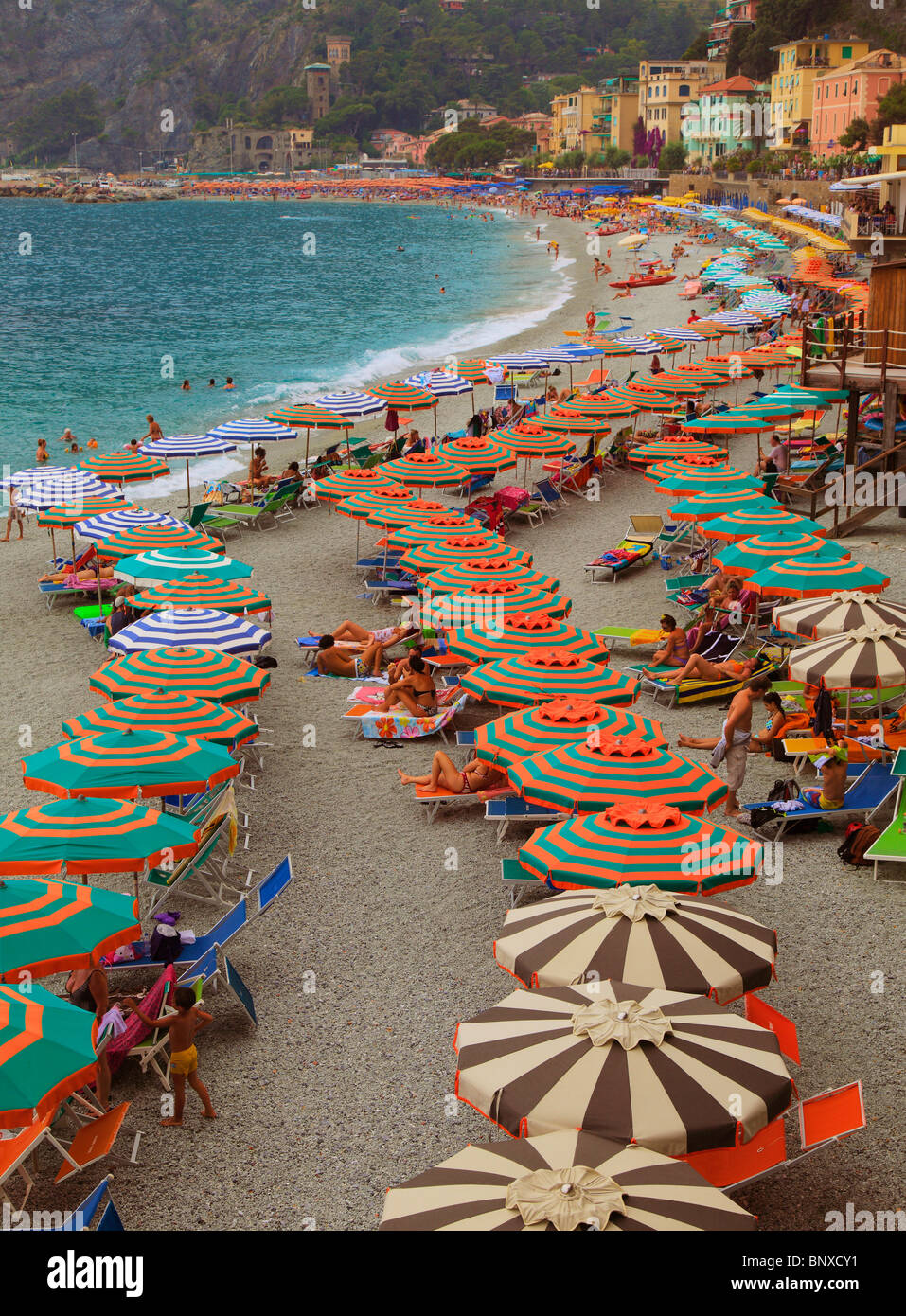 Umbrellas form a curved line on the beach in Monterosso, one of the five towns in Italy's Cinque ...