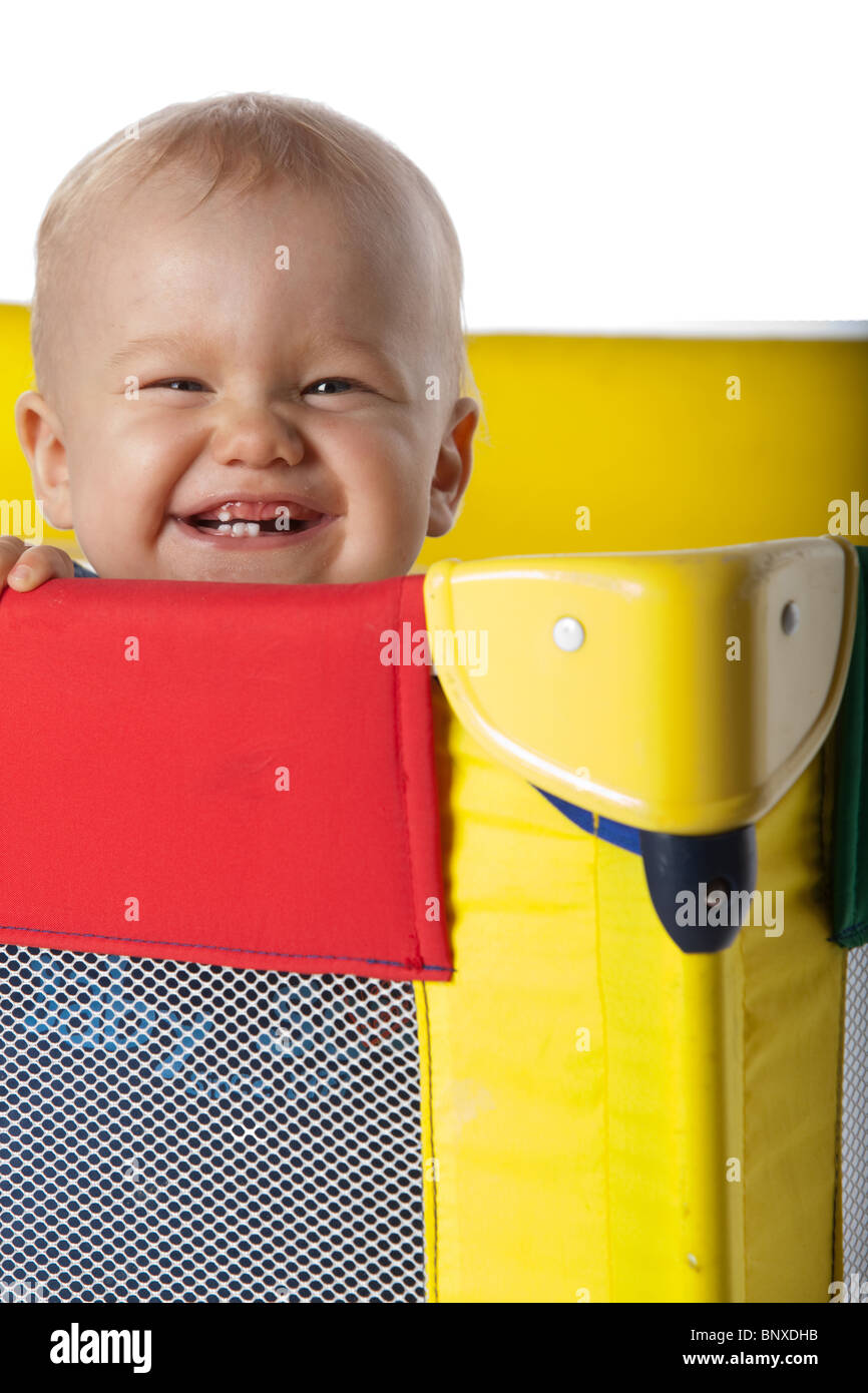 Happy Baby Laughing in Colorful Travelling Cot Stock Photo - Alamy