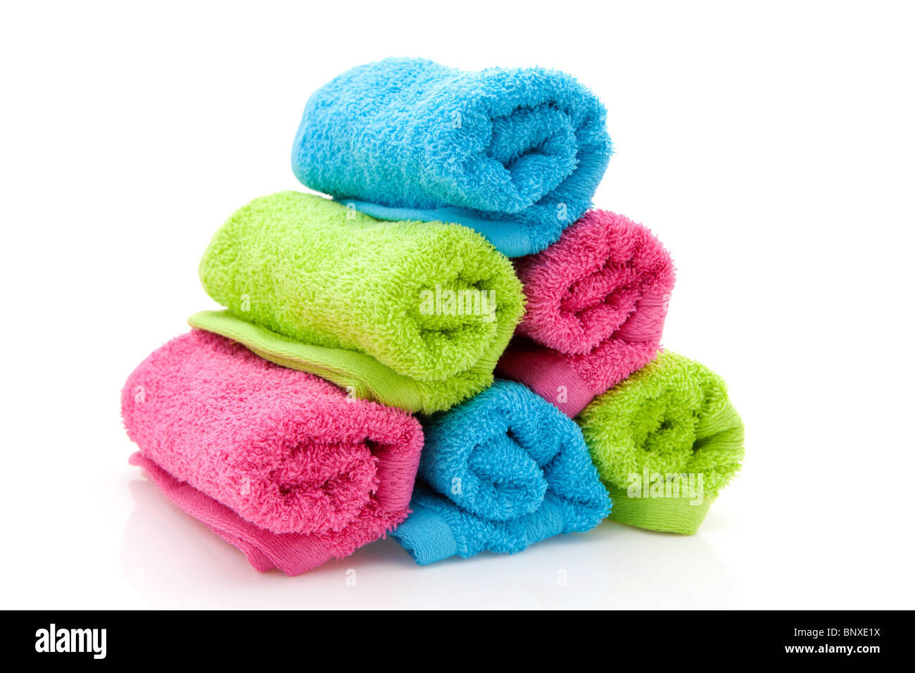 stack of colorful towels rolled isolated on white background Stock ...