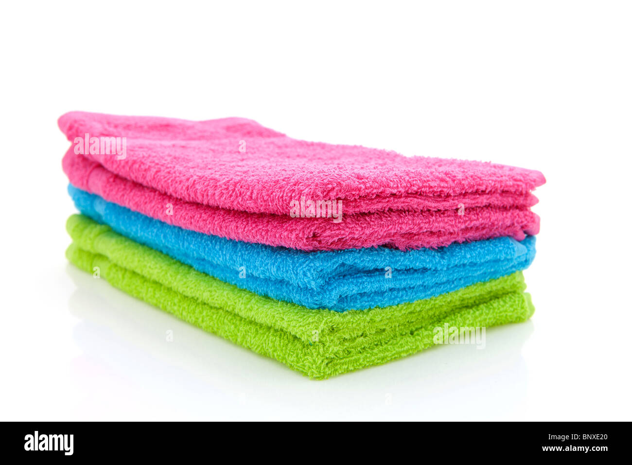 stack of colorful towels isolated on white background Stock Photo - Alamy