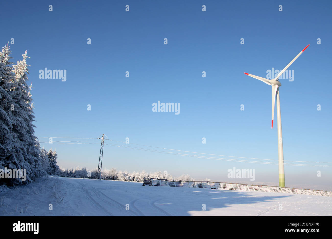 Single wind turbine generating electricity in winter landscape Stock ...