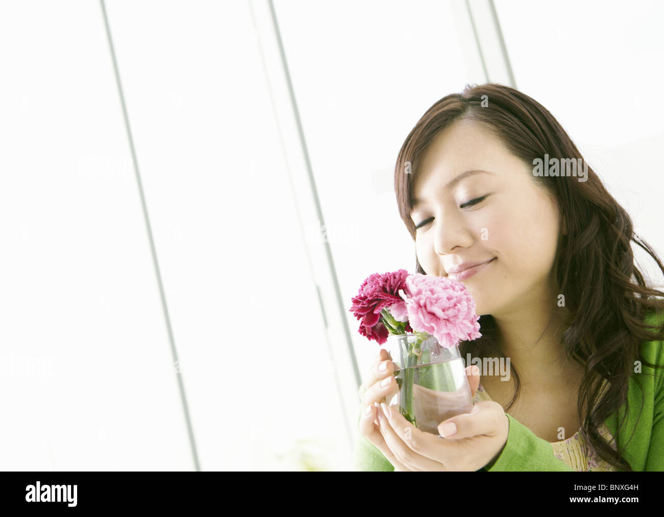 Young woman holding a vace Stock Photo - Alamy