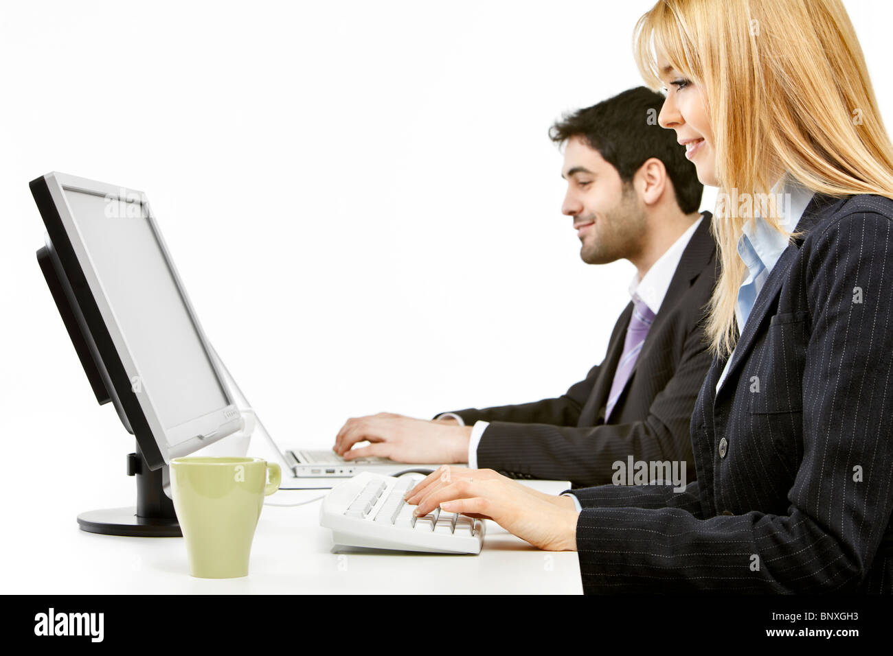 Good looking business people working on computers on white background ...