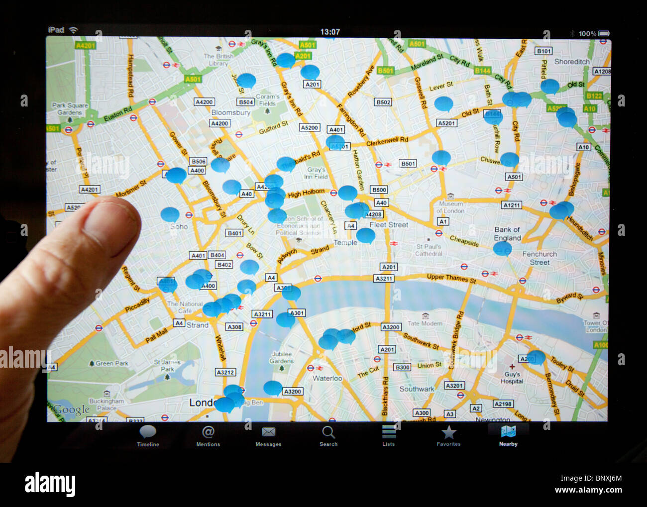 An Apple iPad showing a map with the location of nearby tweeters using ...