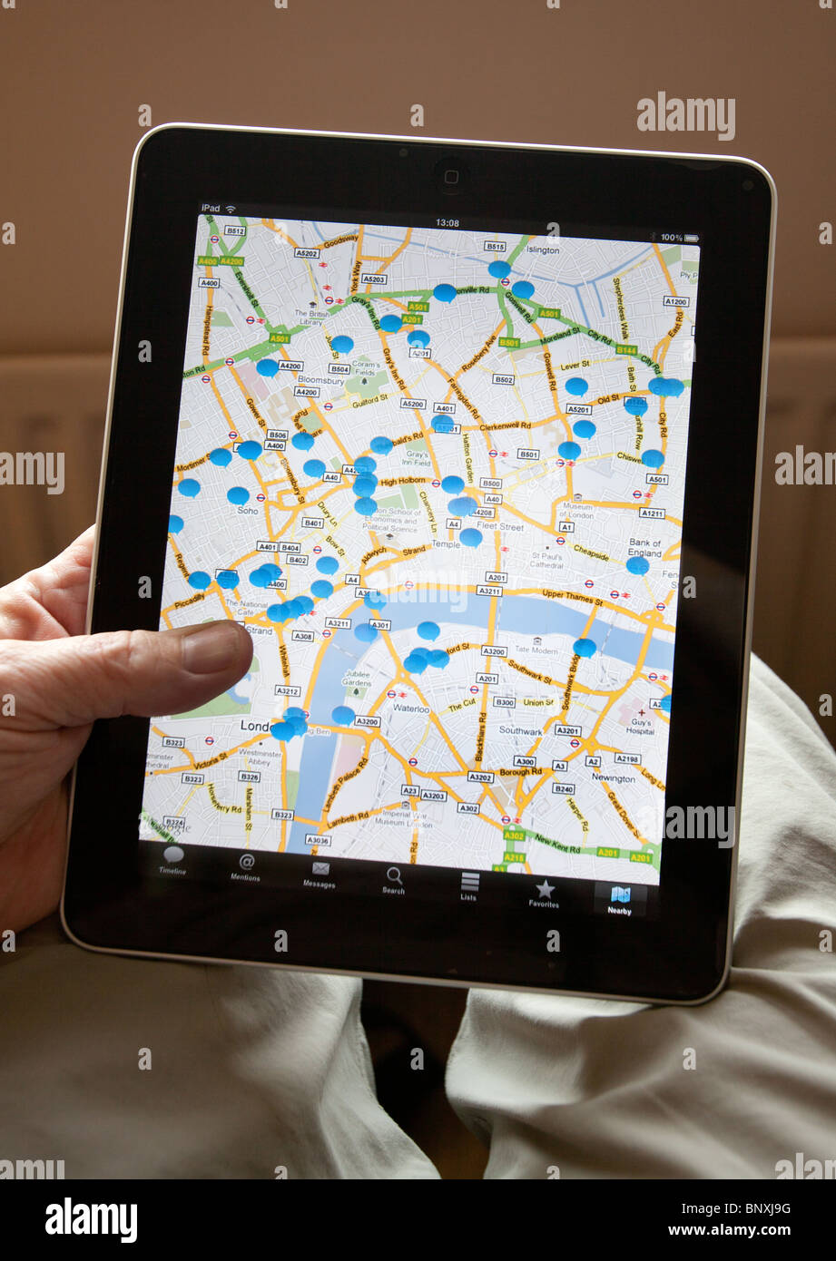 An Apple iPad showing a map with the location of nearby tweeters using ...