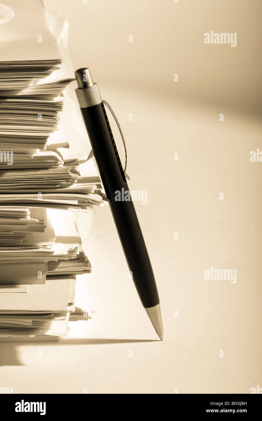 a pen near stack of paper Stock Photo - Alamy