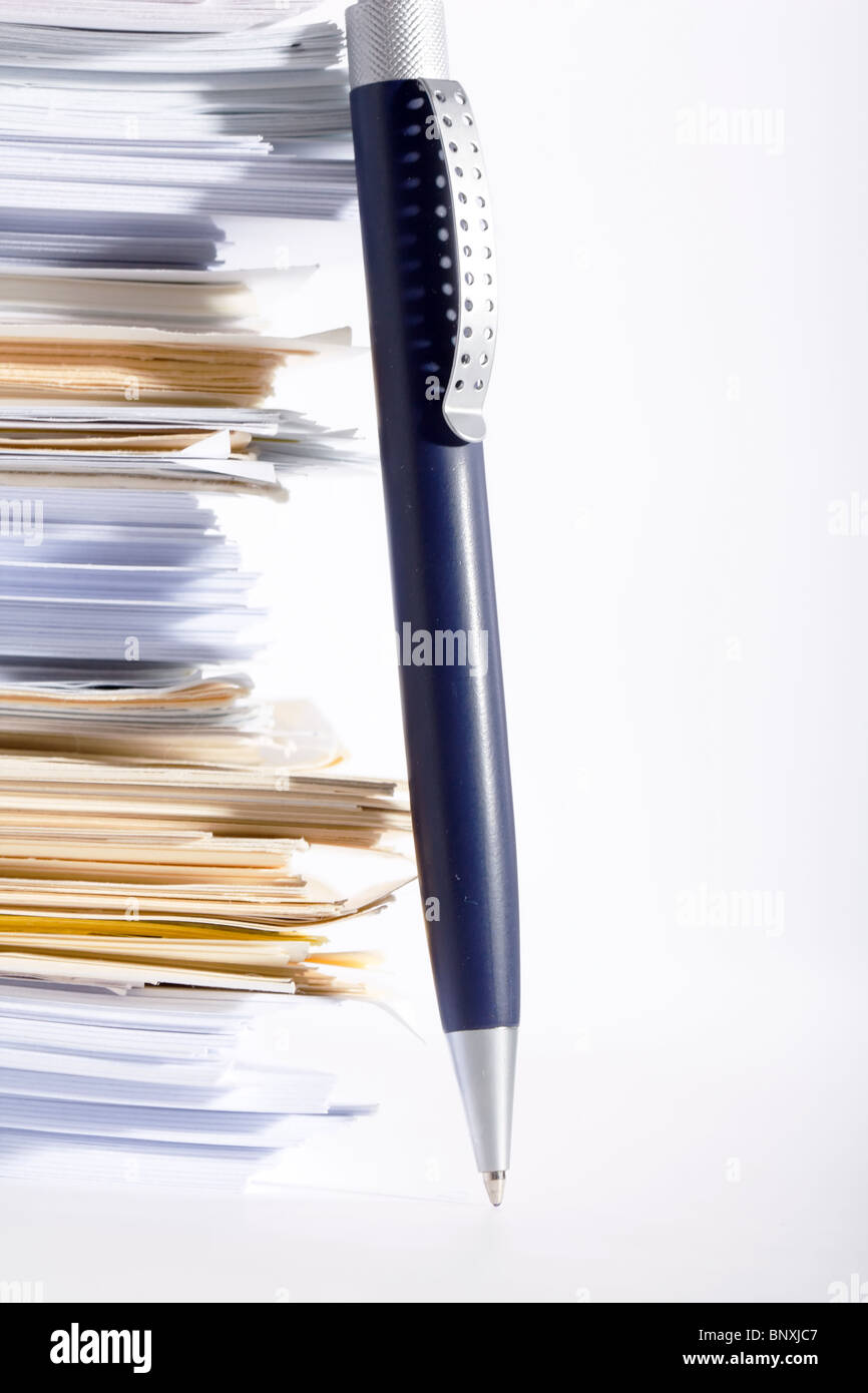 a pen near stack of paper Stock Photo - Alamy