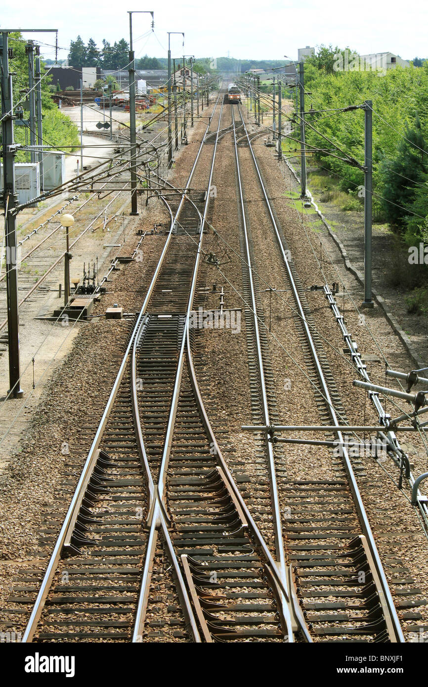 A train on a railway arriving in station Stock Photo - Alamy