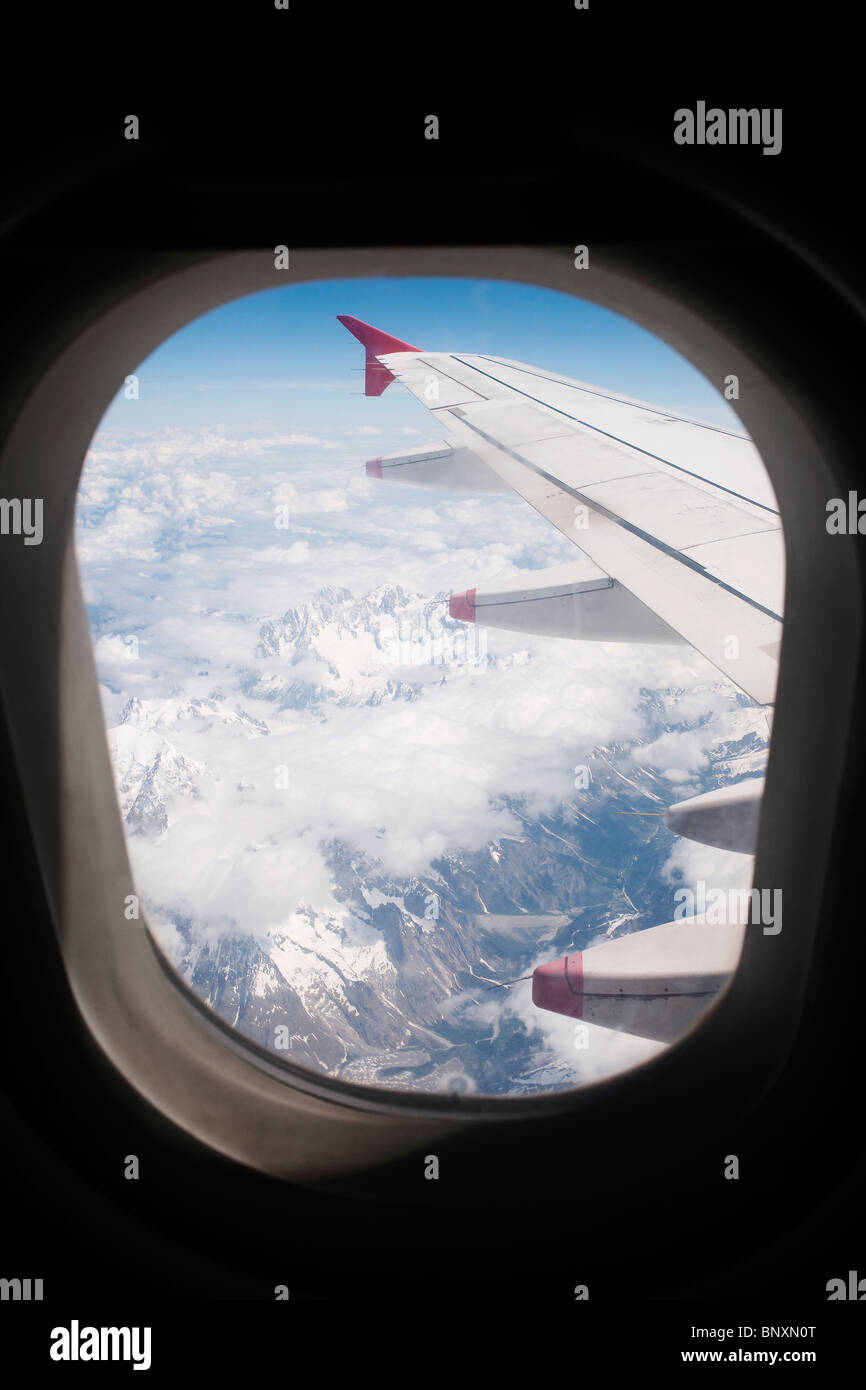 View of The Alps from the window of a passenger Plane Stock Photo - Alamy