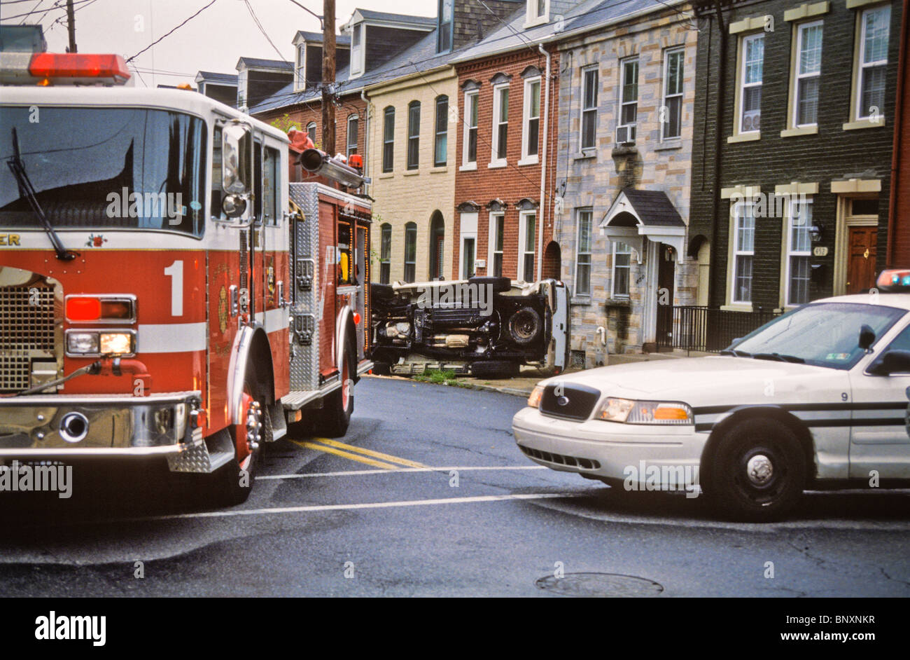 Over turned car at accident scene, police and fire truck Stock Photo ...