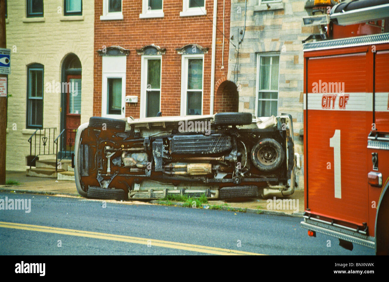 Over turned car at accident scene, police and fire truck Stock Photo ...