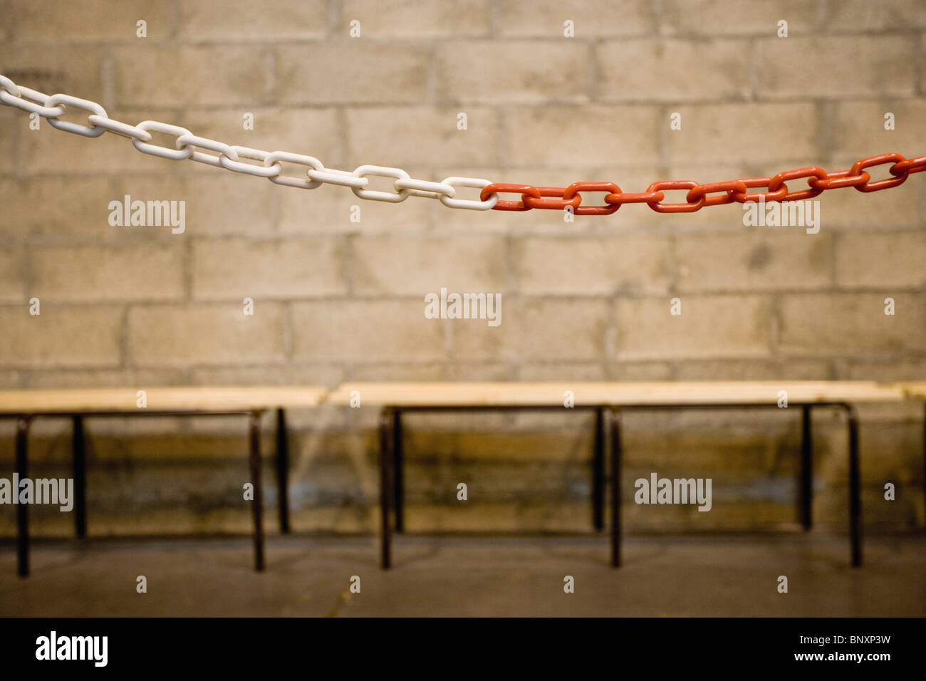 Benches behind chain barrier Stock Photo - Alamy