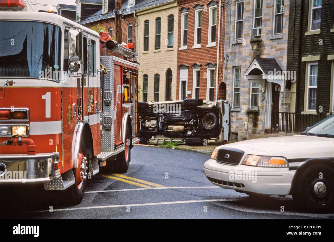 Over turned car at accident scene, police and fire truck Stock Photo ...
