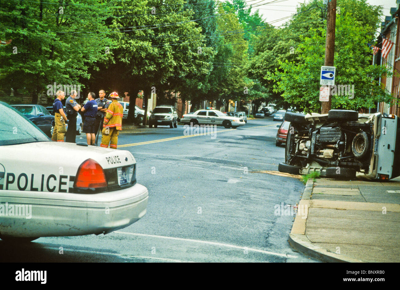 Over turned car at accident scene, police and fire truck Stock Photo ...