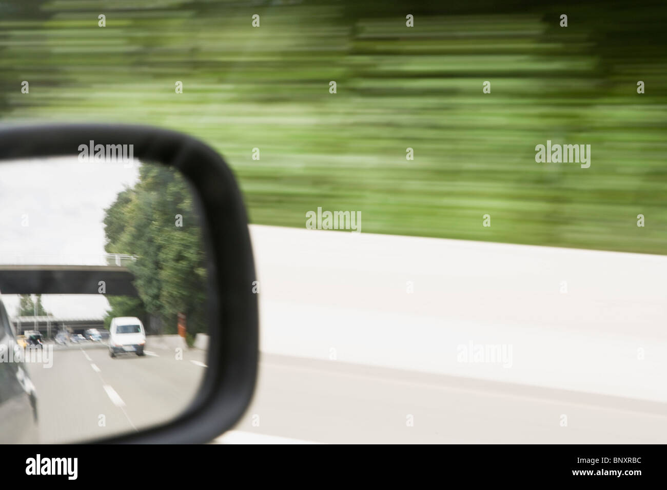 Approaching car seen in side-view mirror Stock Photo - Alamy
