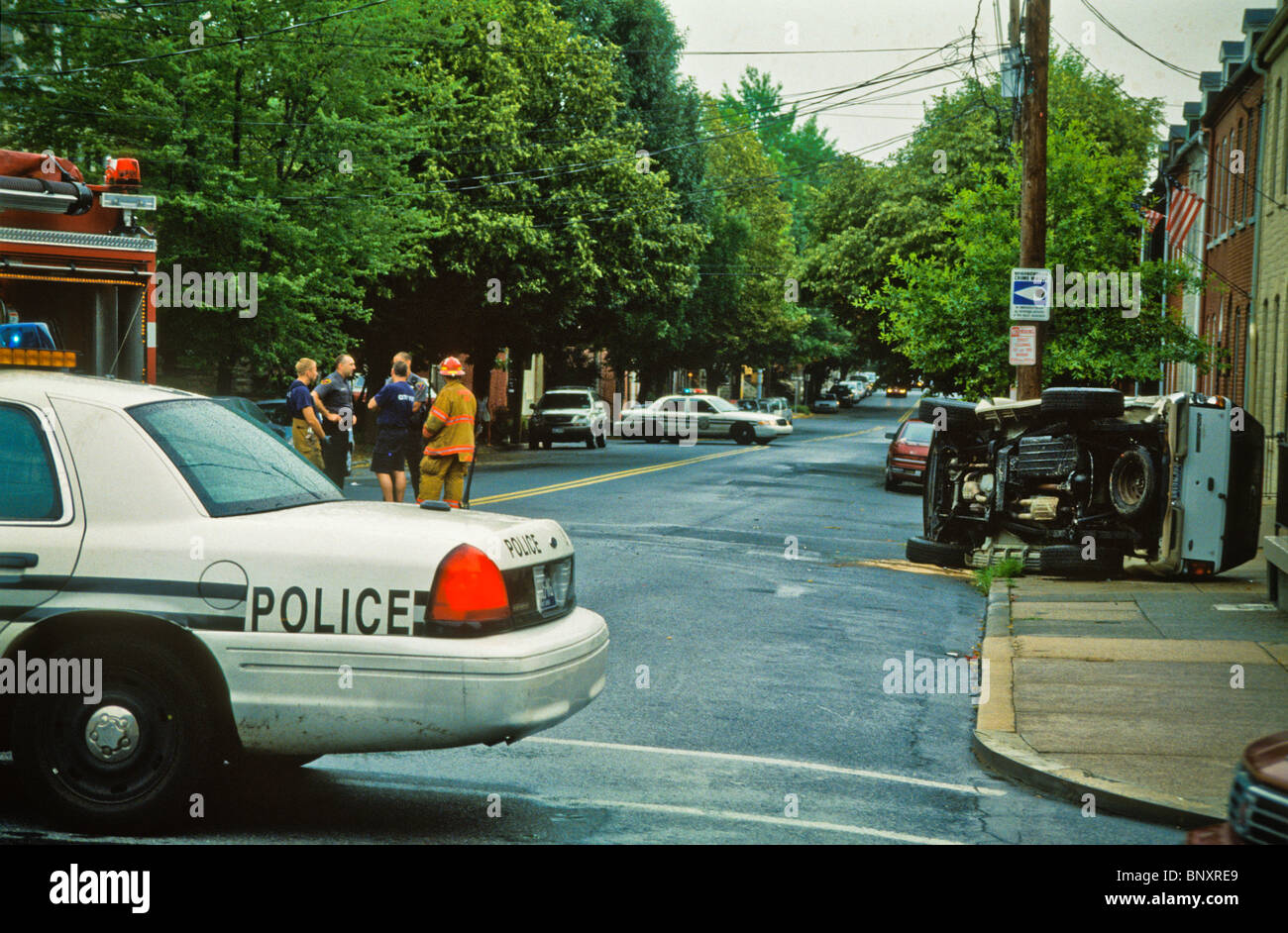 Over turned car at accident scene, police and fire truck Stock Photo ...