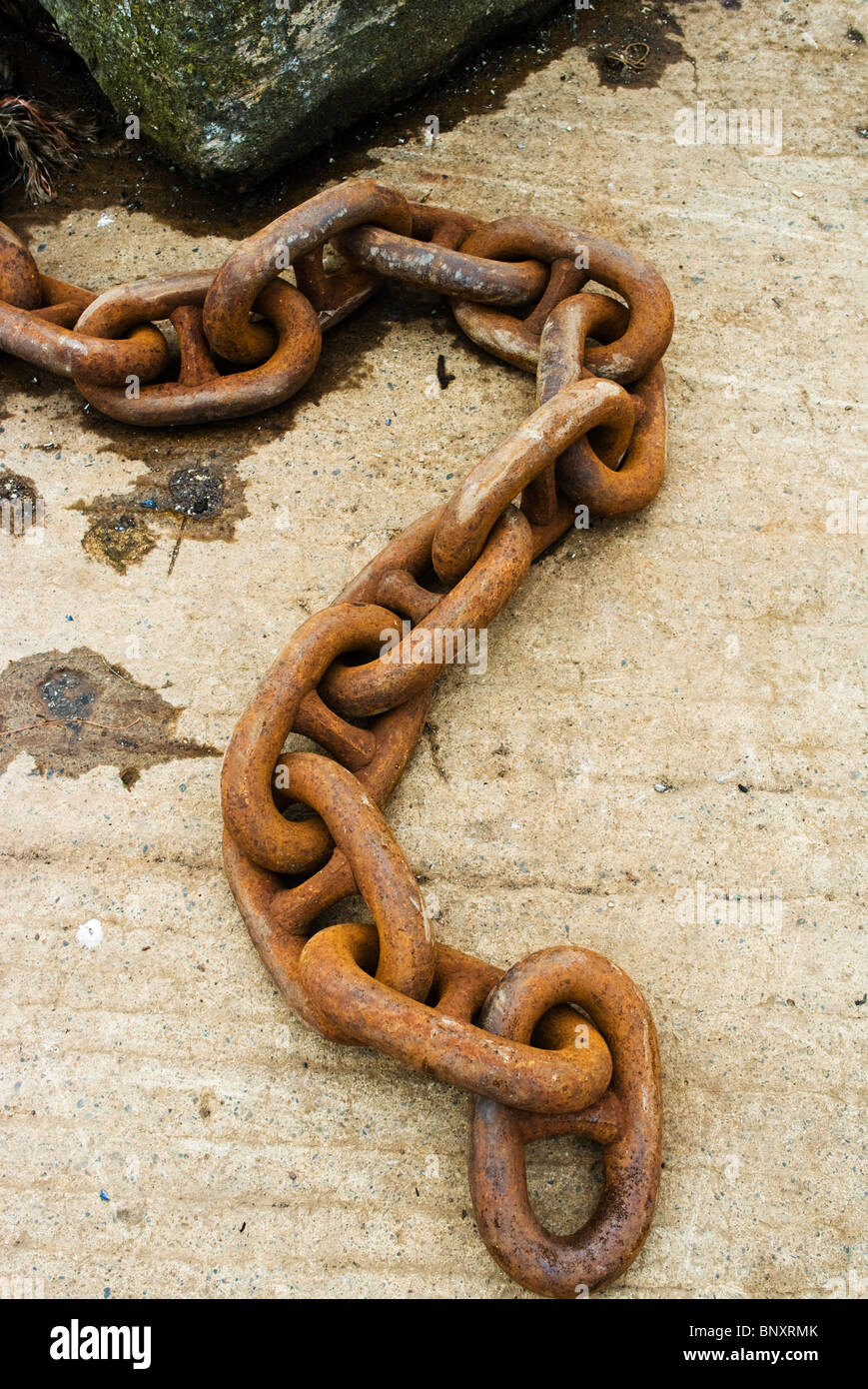 A strong rusty iron chain for mooring boats on the quay Stock Photo - Alamy