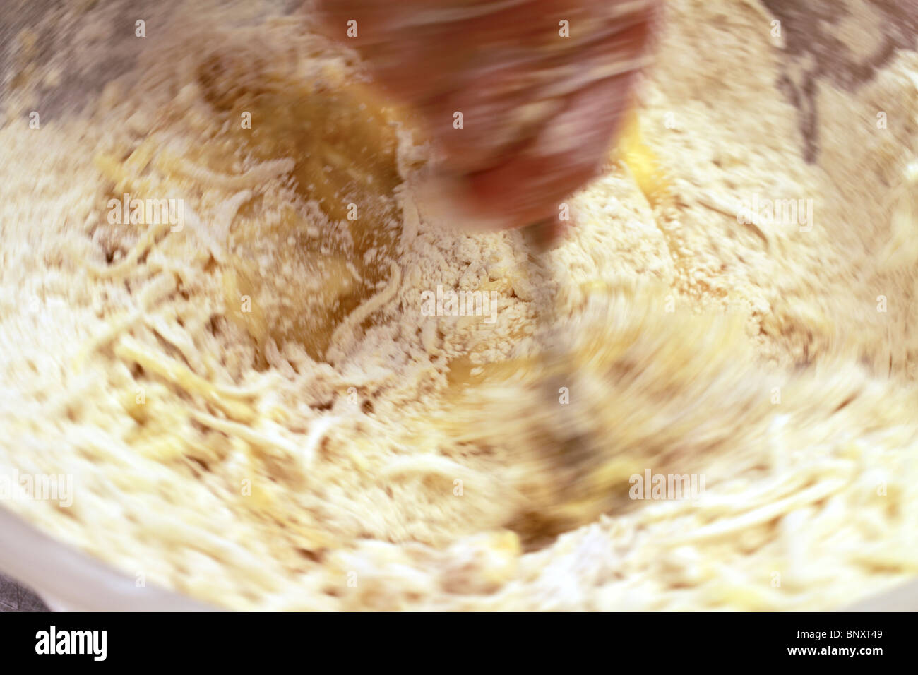 Making cheese scones - stirring the mixture Stock Photo - Alamy