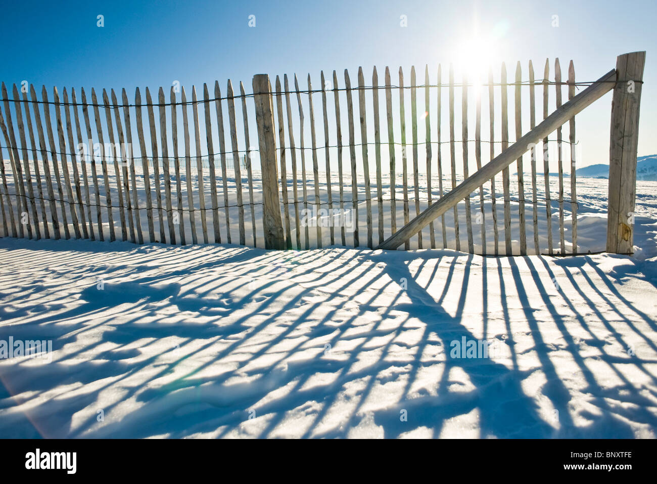 Wooden fence in snow covered field Stock Photo - Alamy