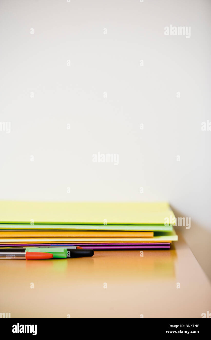 Folders stacked on table Stock Photo - Alamy