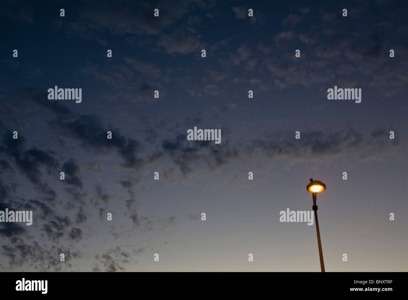Street lamp glowing at twilight Stock Photo - Alamy