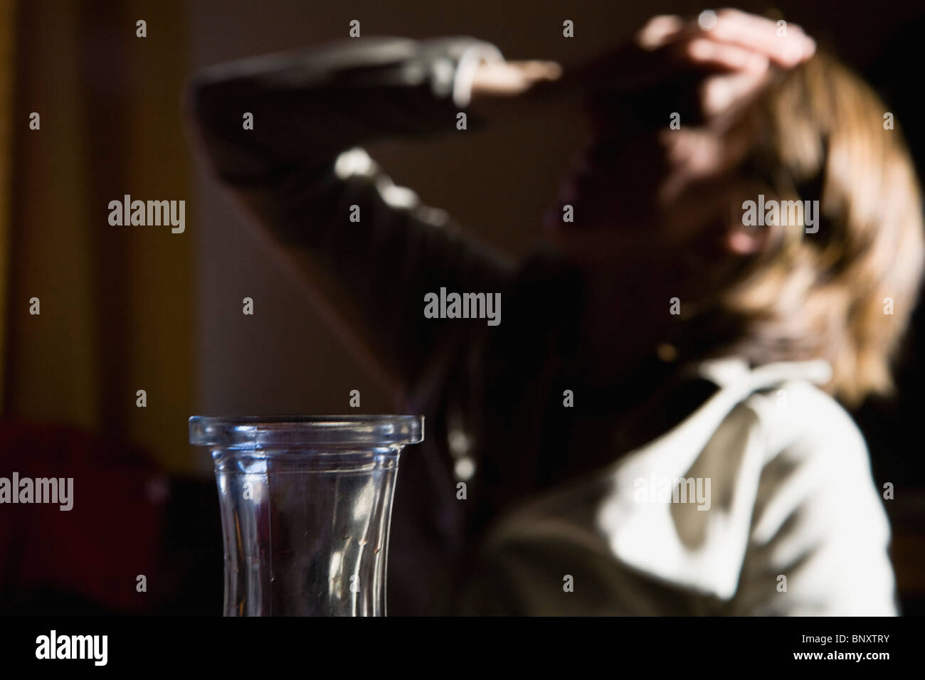 Woman holding head in disbelief Stock Photo - Alamy