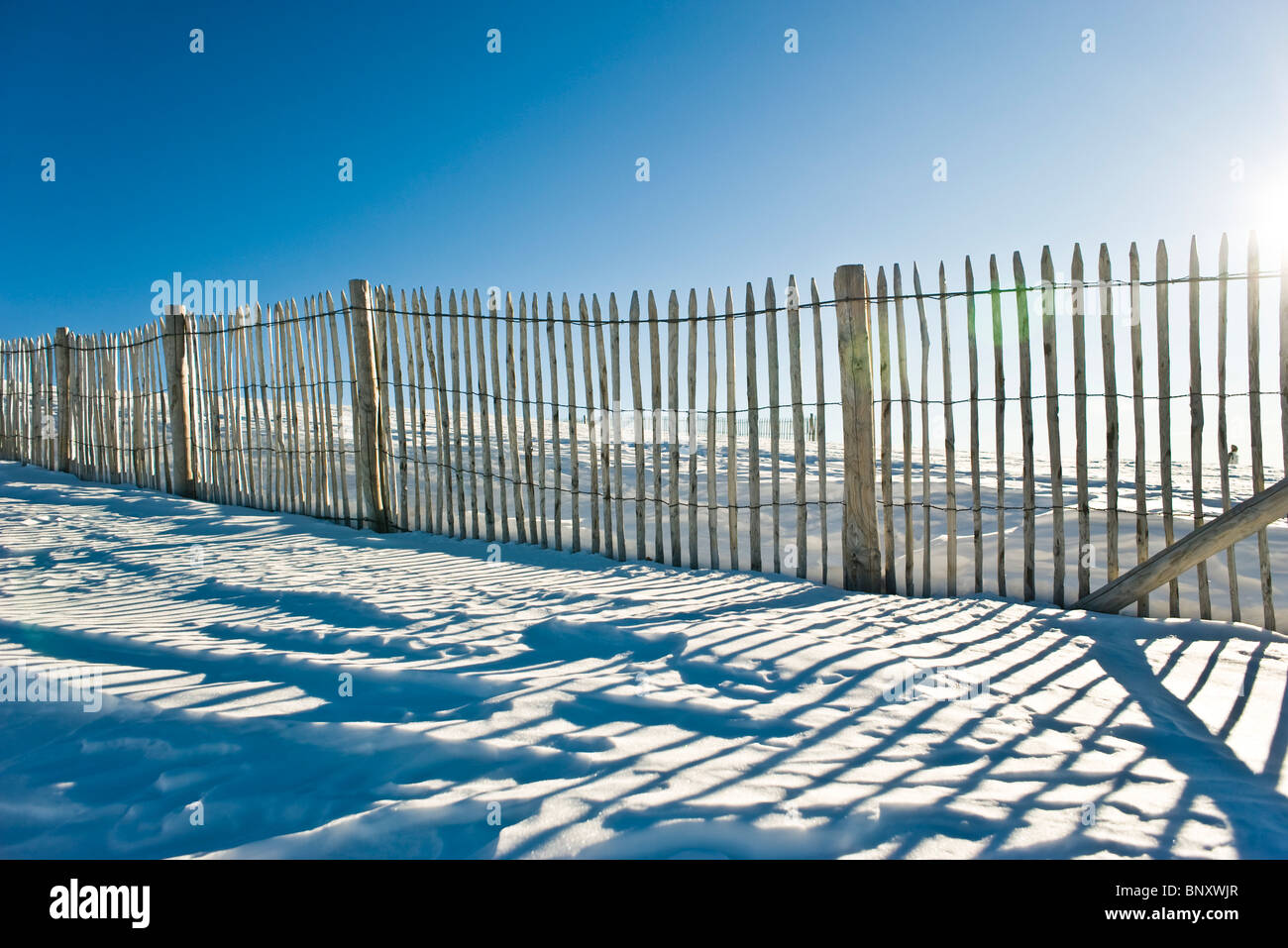 Wooden fence in snow covered field Stock Photo - Alamy