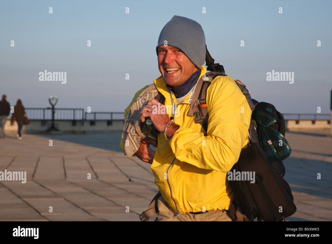 Hiker on the summit of Mount Washington at sunset in the White ...