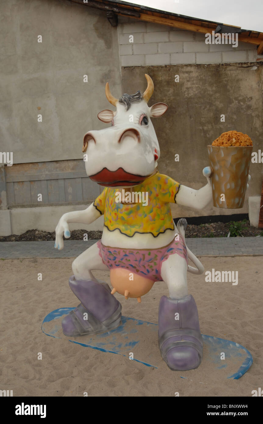 Statue of a cow on a snowboard or a surfboard Stock Photo - Alamy