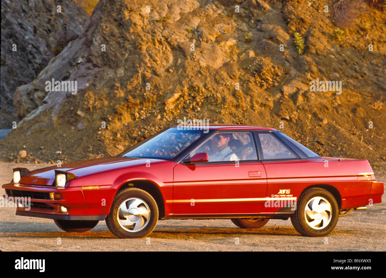 Red car on rural highway Stock Photo - Alamy