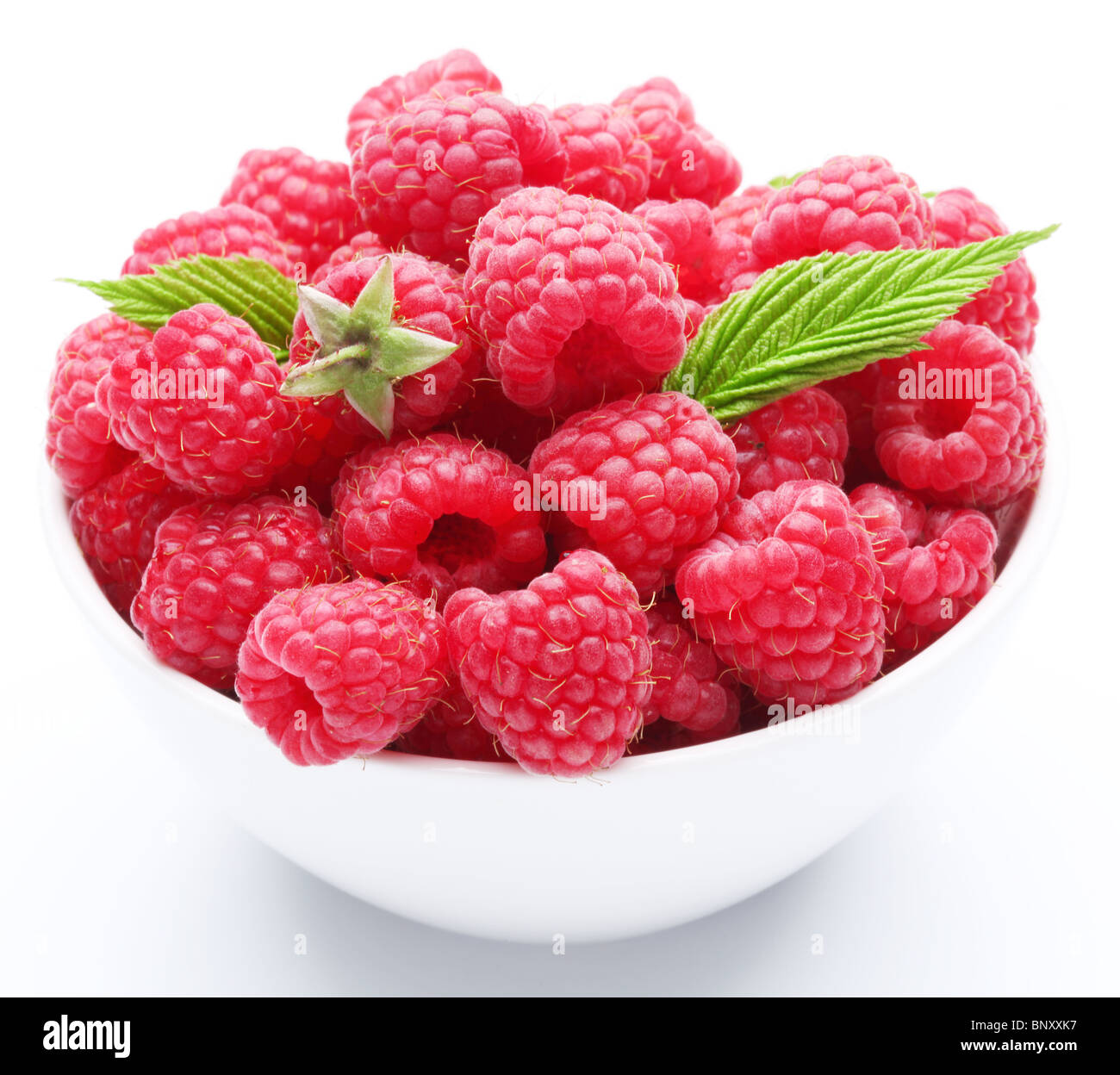 Crockery with beautiful tempting raspberries Isolated on white ...