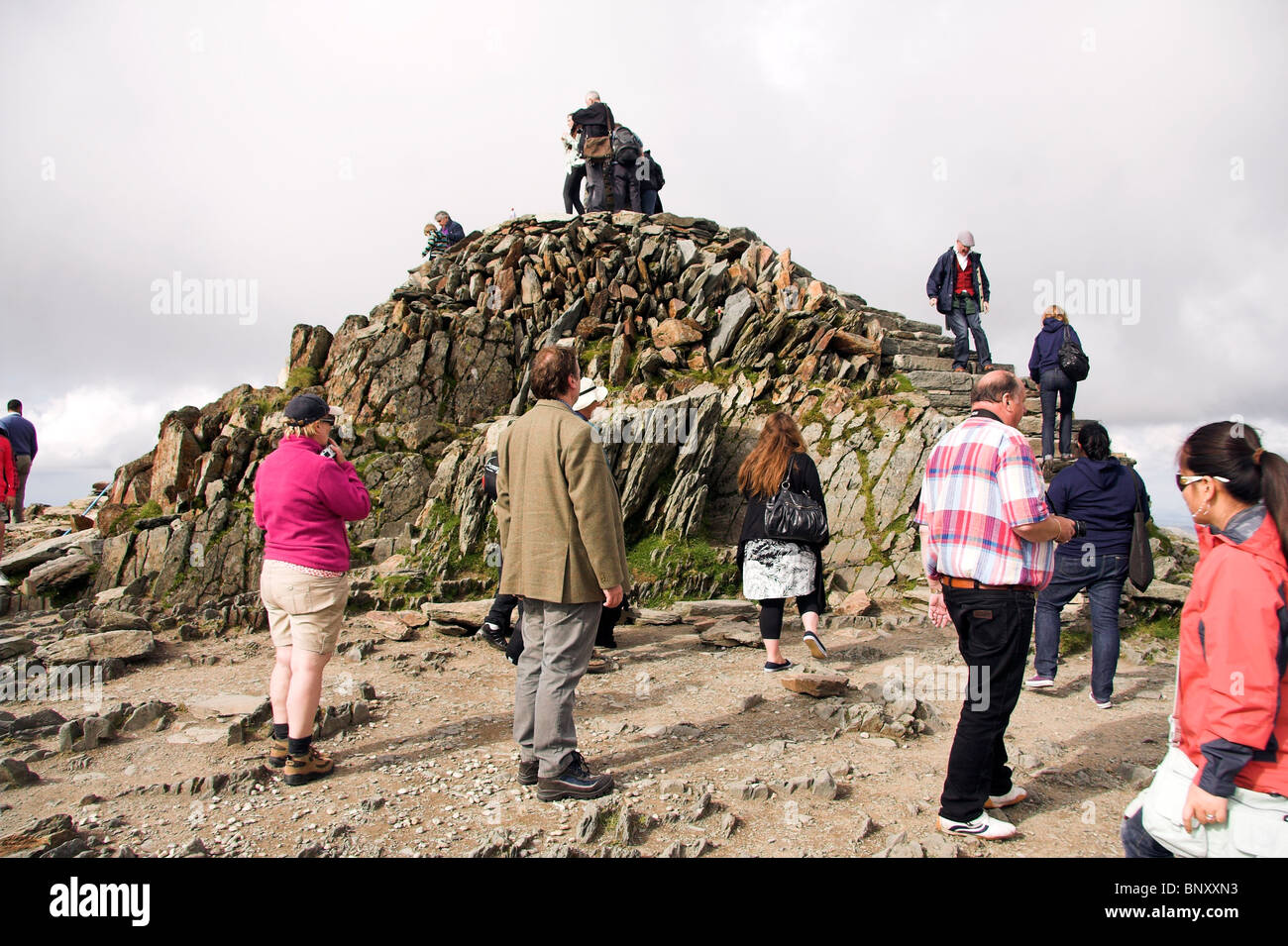 Hikers crowd Mount Snowdon summit, Snowdonia National Park, North Wales ...