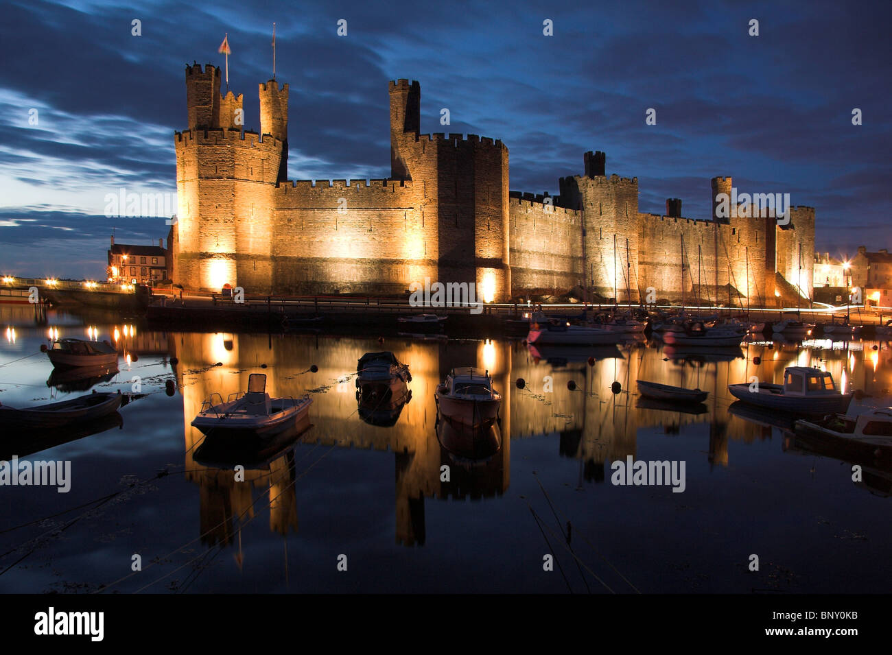 Caernarfon Castle lit up at night, North Wales, UK Stock Photo - Alamy