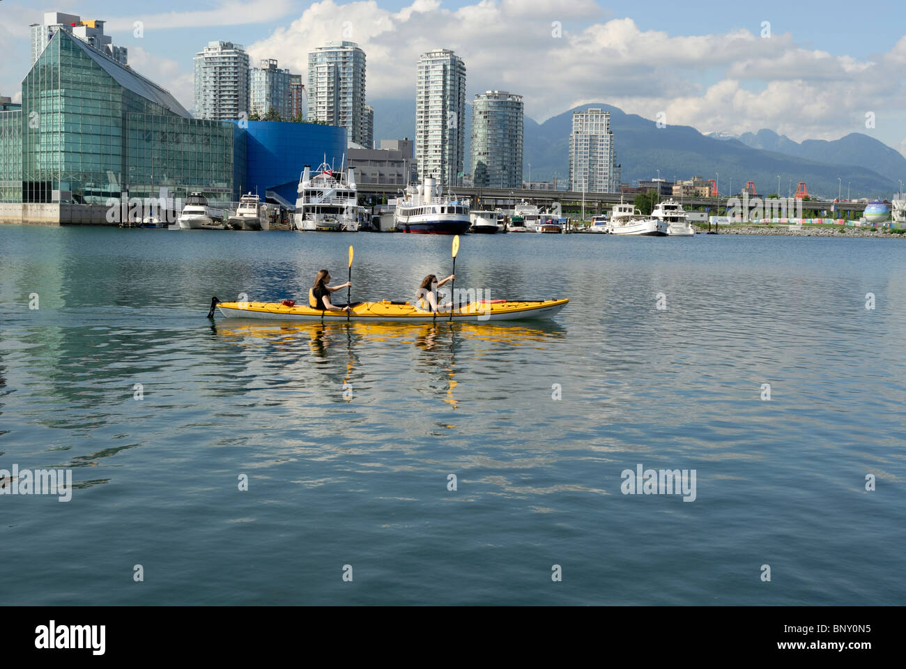 Female Kayakers paddling on the waters of False Creek harbour with ...