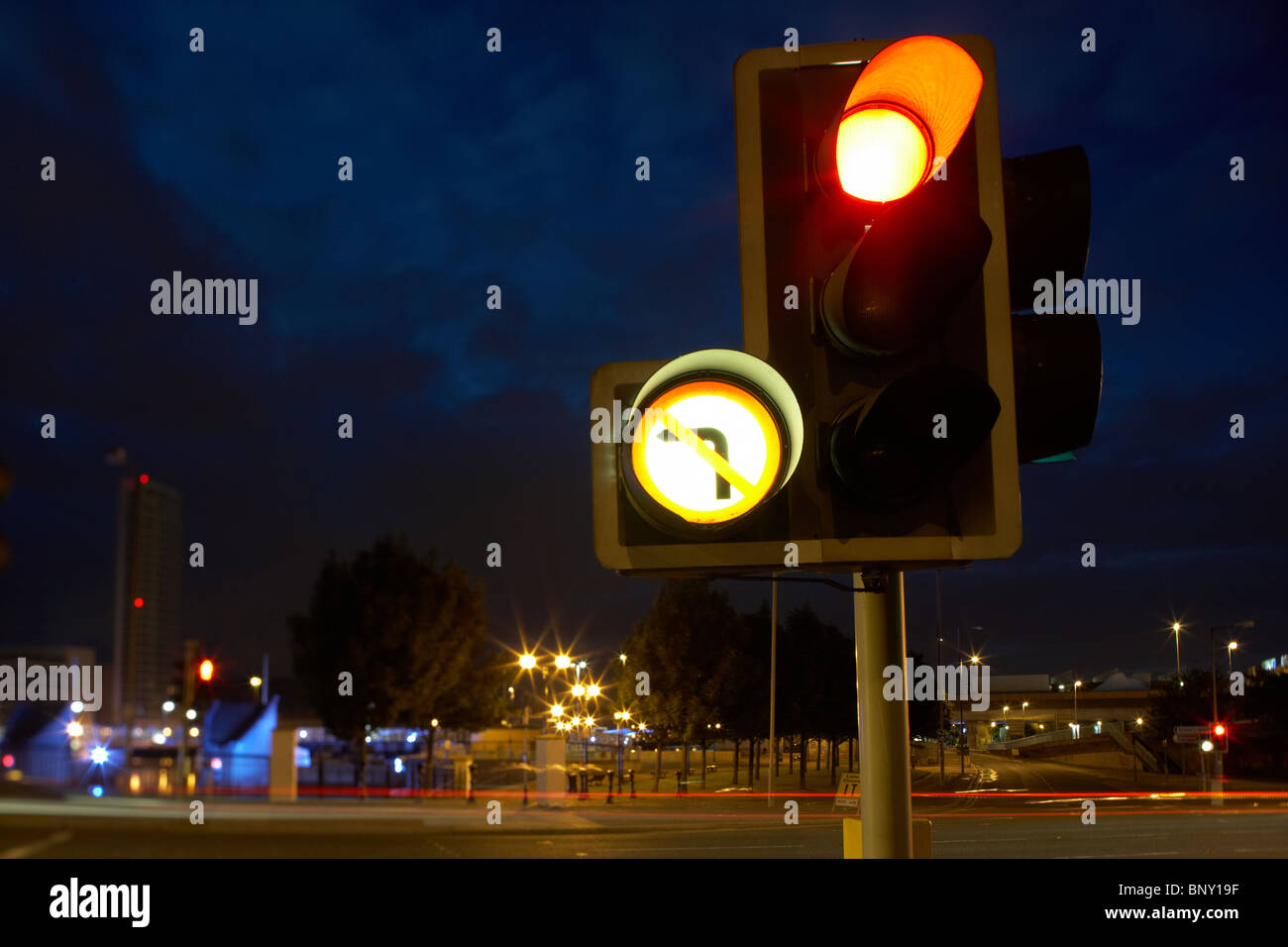 red streetlight stop no left turn sign on roadway at night Belfast ...