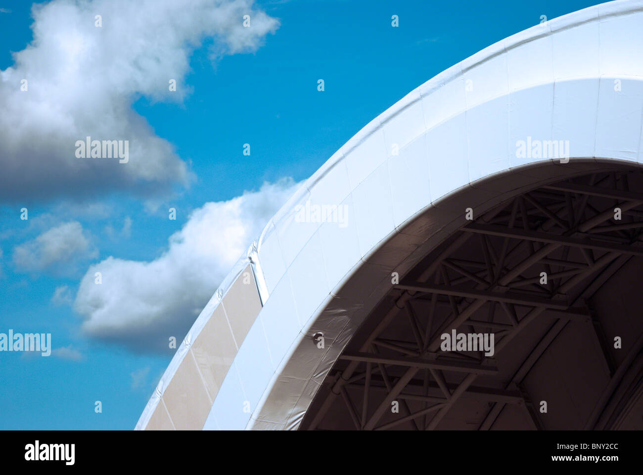Partial view of white amphitheater stage canopy - against bright blue ...