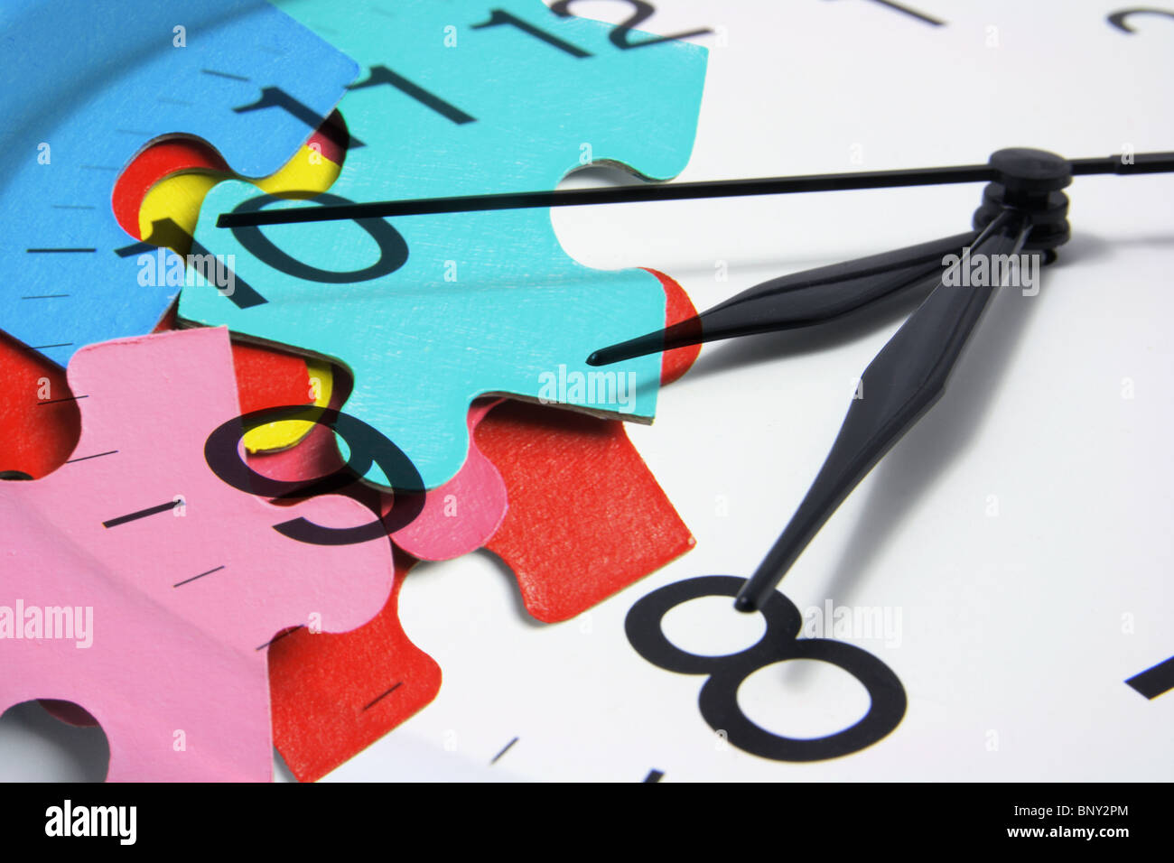 Clock and Jigsaw Puzzle Pieces Stock Photo - Alamy
