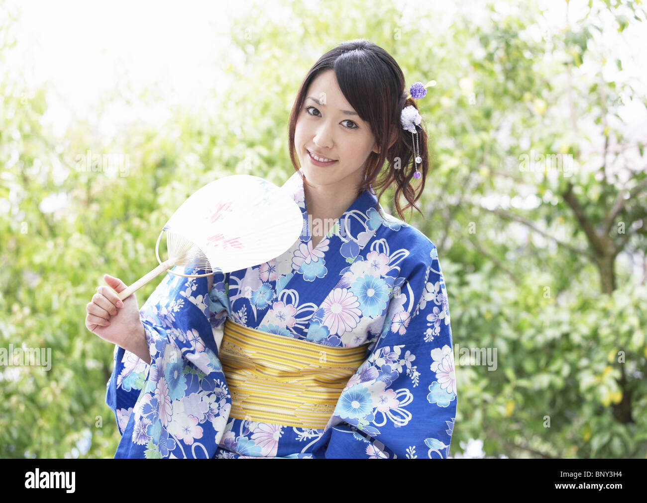Woman holding paper fan hi-res stock photography and images - Alamy