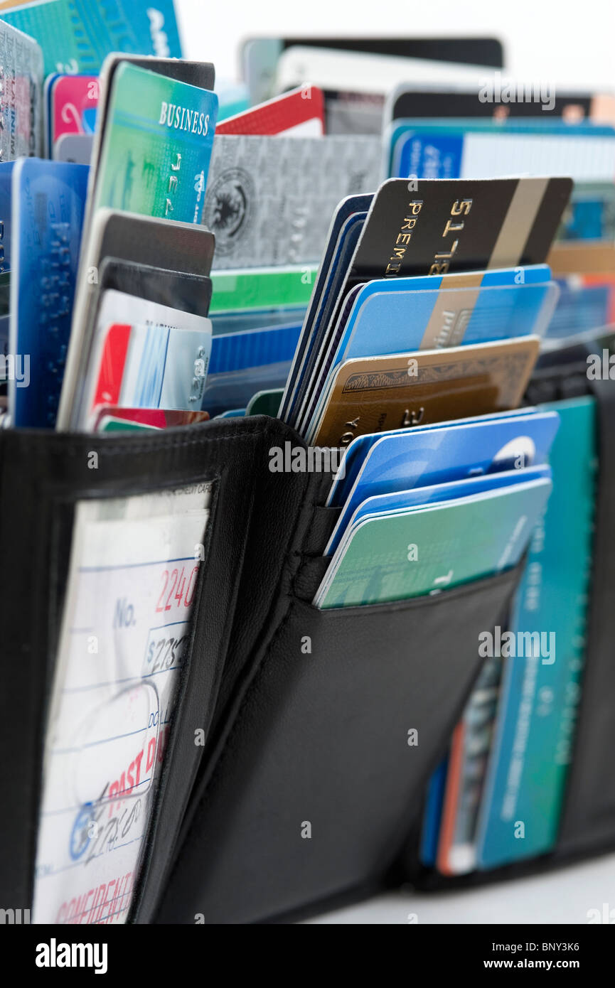 Wallet stuffed with credit cards on a white background studio image ...