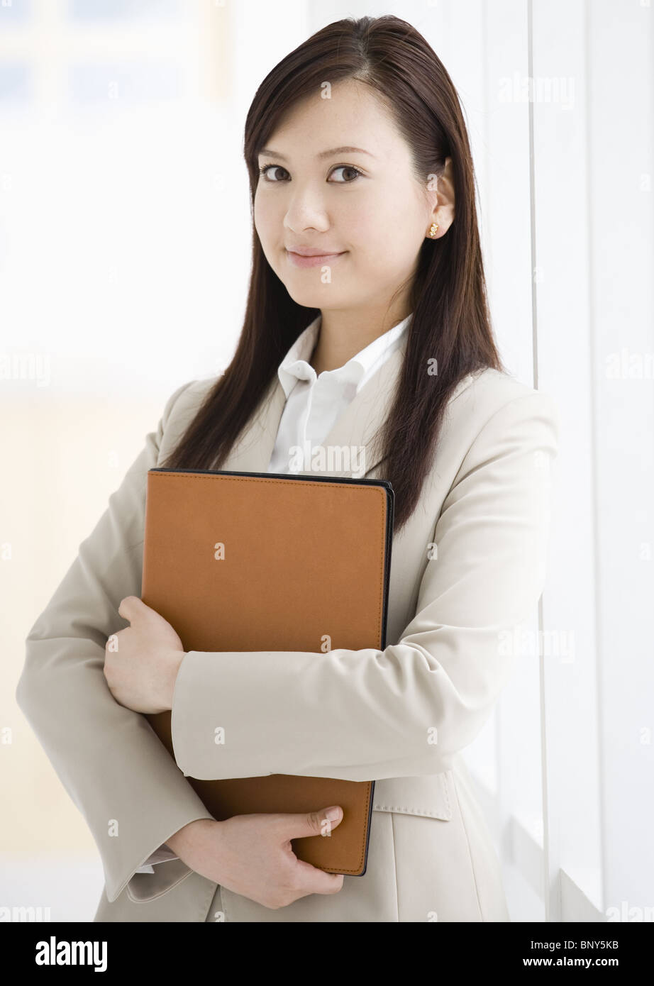 Business woman holding files Stock Photo - Alamy