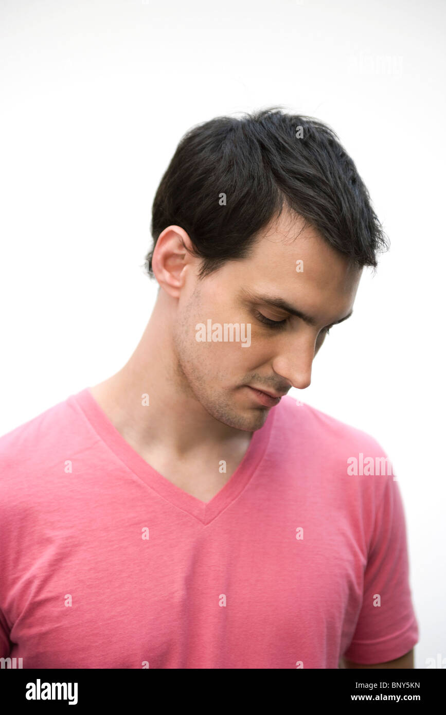 Young man looking down, portrait Stock Photo - Alamy