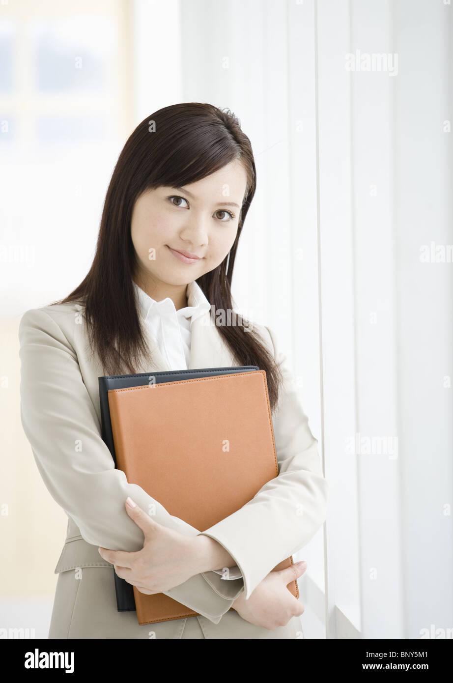 Business woman holding files Stock Photo - Alamy