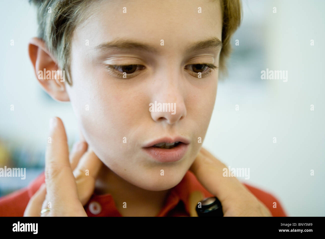 Examining young patient's lymph nodes Stock Photo - Alamy