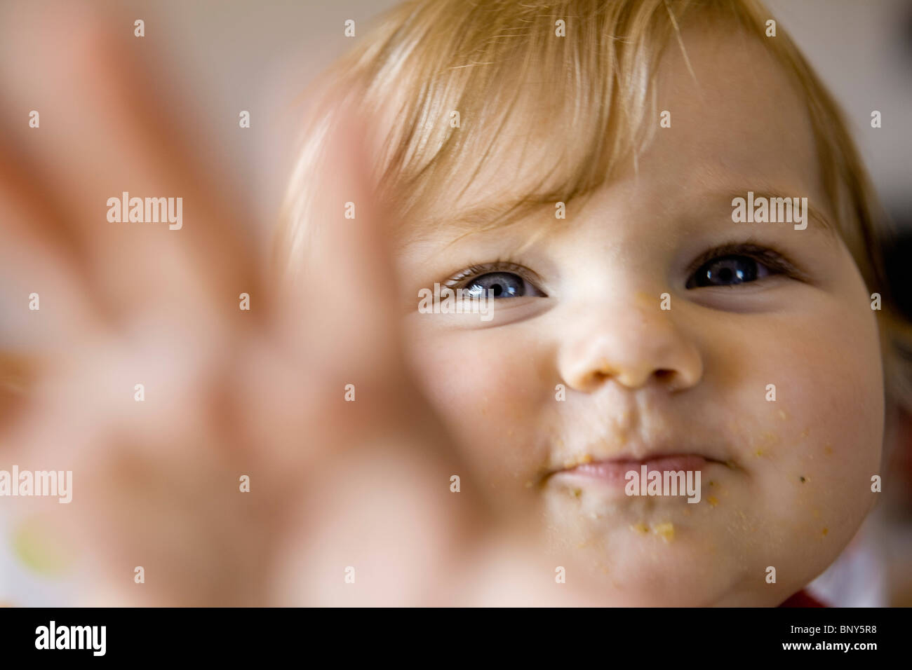 Infant reaching toward camera, portrait Stock Photo - Alamy