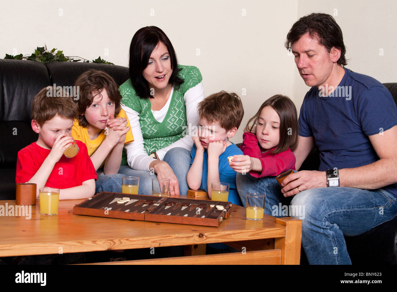 Big family is playing a boardgame in the livingroom Stock Photo - Alamy
