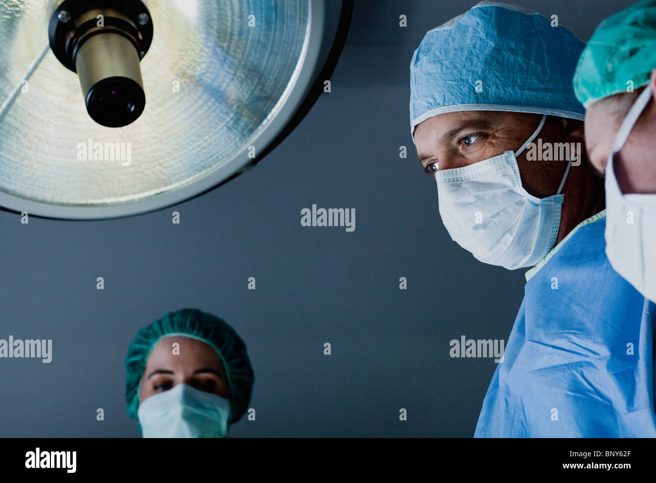 Surgical team at work operating room Stock Photo - Alamy