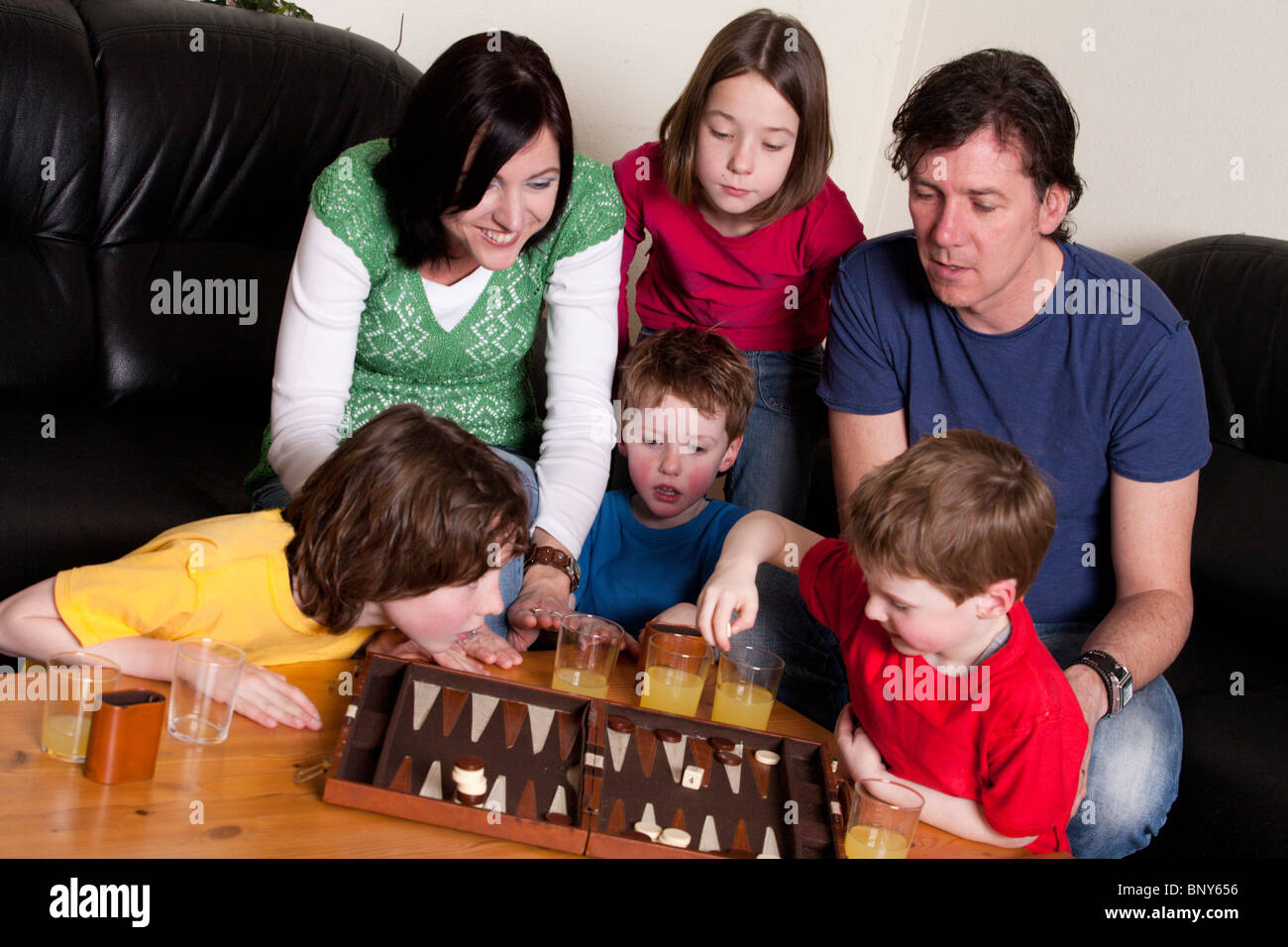 Big family is playing a boardgame in the livingroom Stock Photo - Alamy