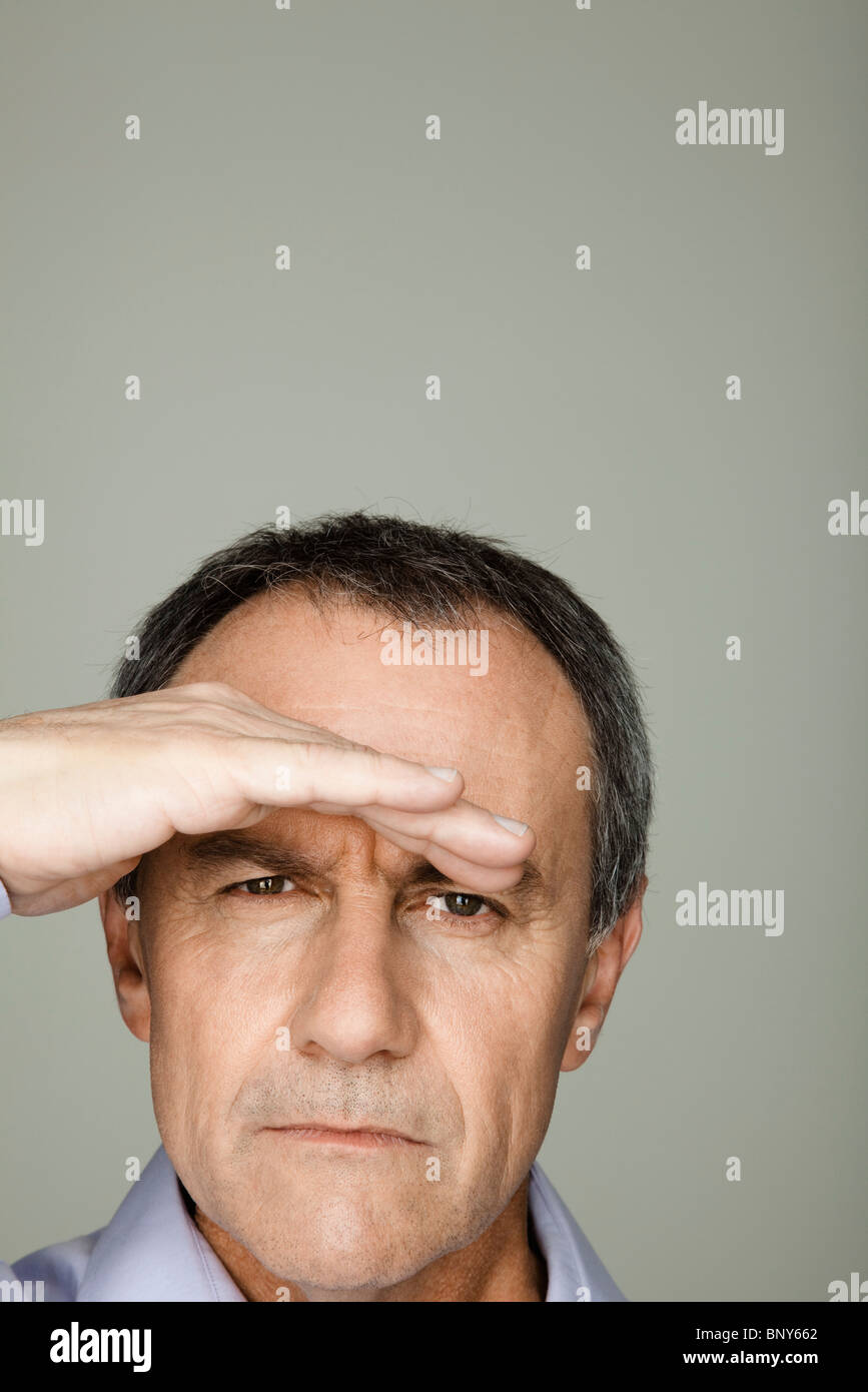 Man shading eyes one hi-res stock photography and images - Alamy